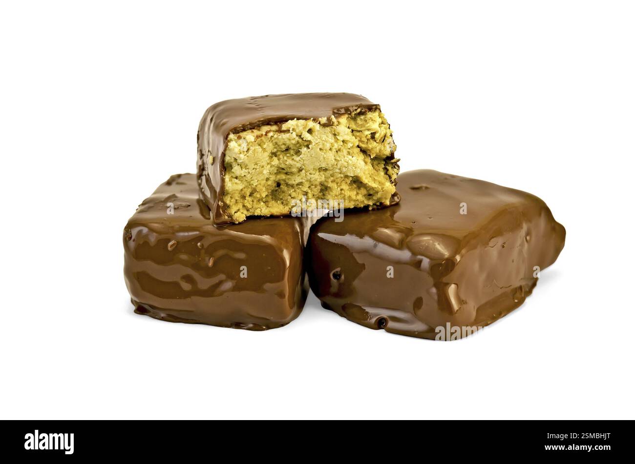 Two whole and one half of halva glazed with chocolate isolated on white ...