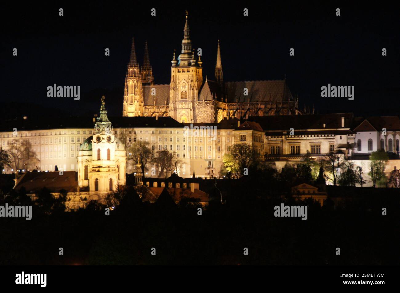 Prague Castle, a majestic complex of buildings illuminated at night ...