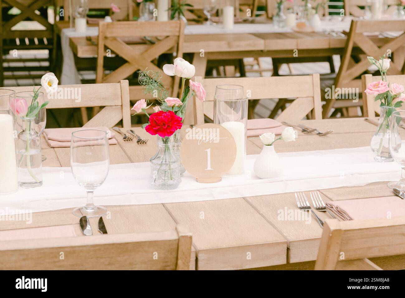 A beautifully arranged outdoor dining area features wooden tables ...