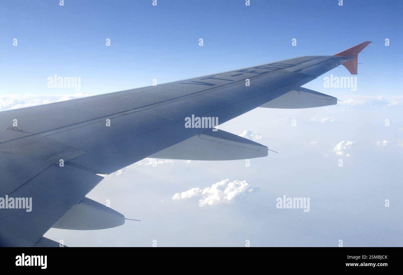 Air transport, view of wing and clouds in blue sky from aeroplane ...