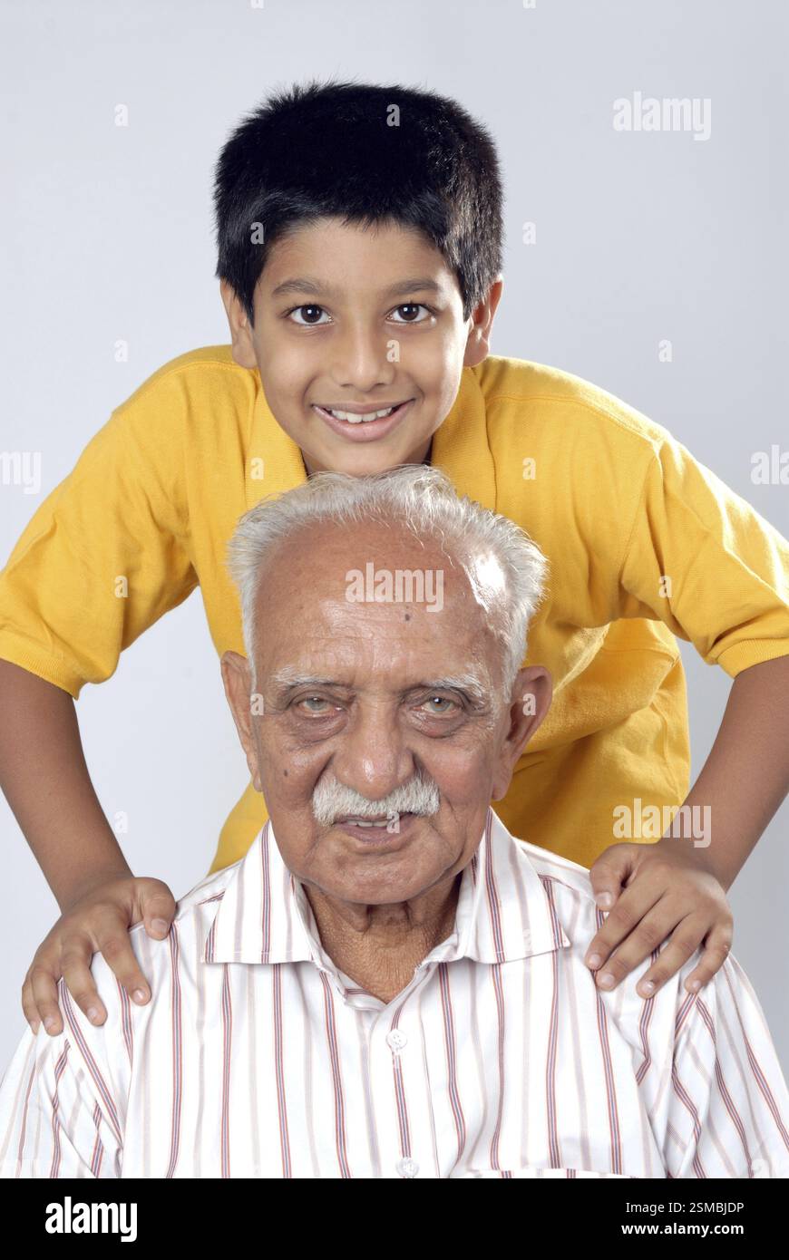 South Asian Indian grandfather and grandson looking at camera MR#152 ...