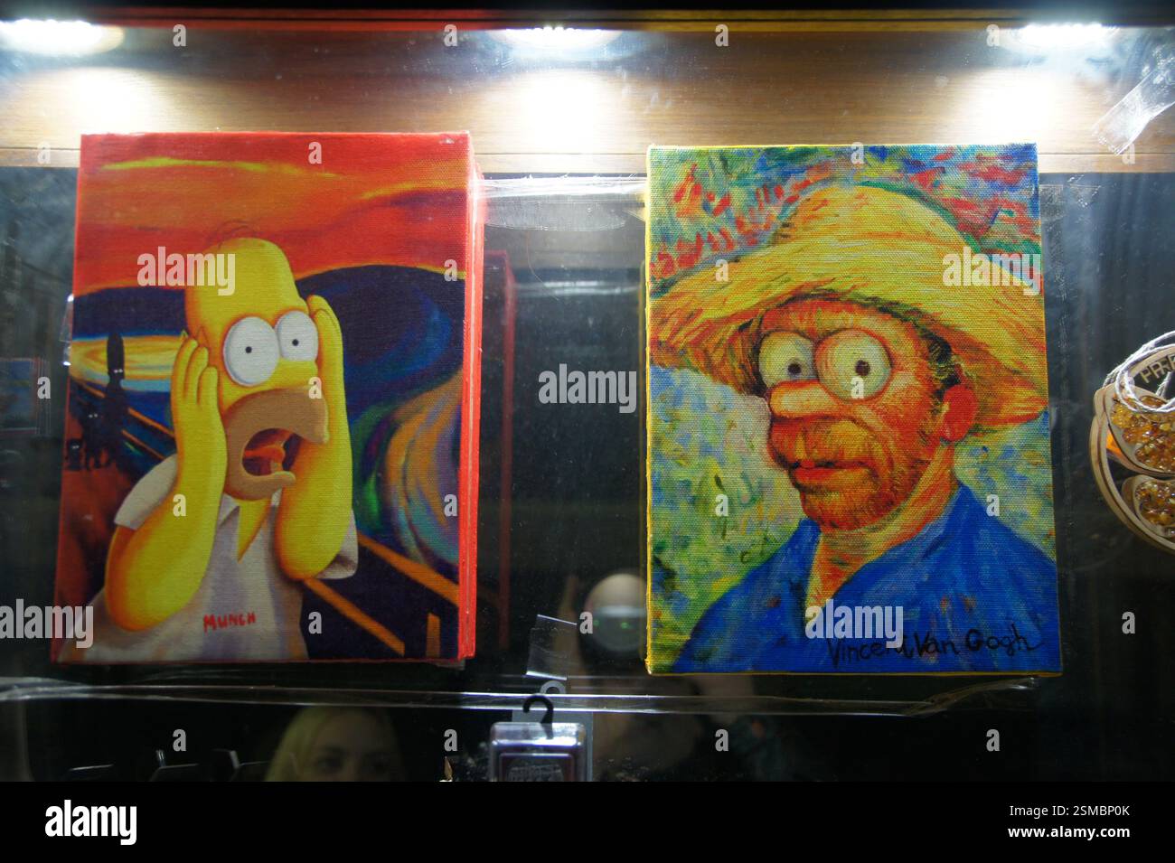 Two small paintings side by side. Yellow cartoon character Homer ...