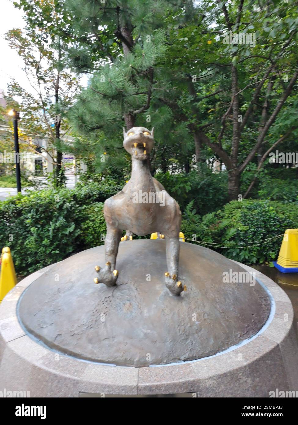 Mythical creature statue stands guard in vibrant garden filled with ...