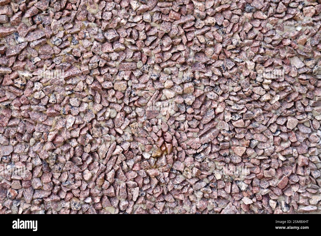 The wall, built of fine granite gravel red, reinforced cement Stock ...