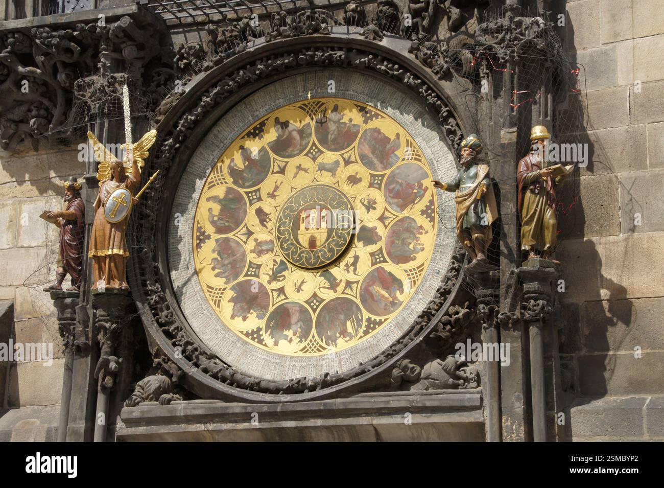Prague Astronomical Clock. Ornate medieval clock face. Golden zodiac signs and religious figures ...