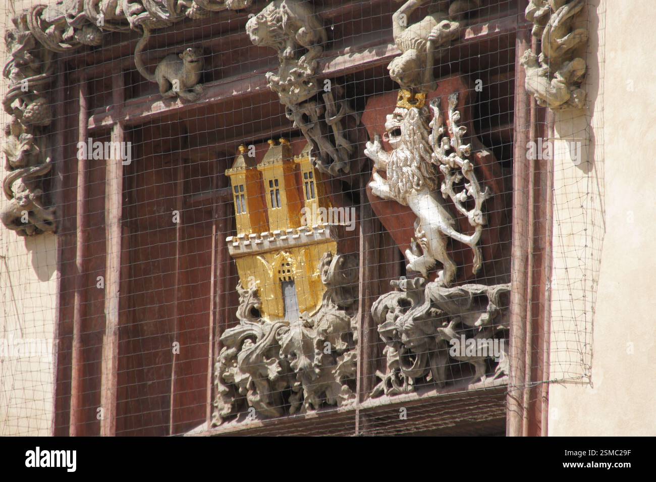 Ornate stonework with a golden coat of arms featuring a lion and a ...