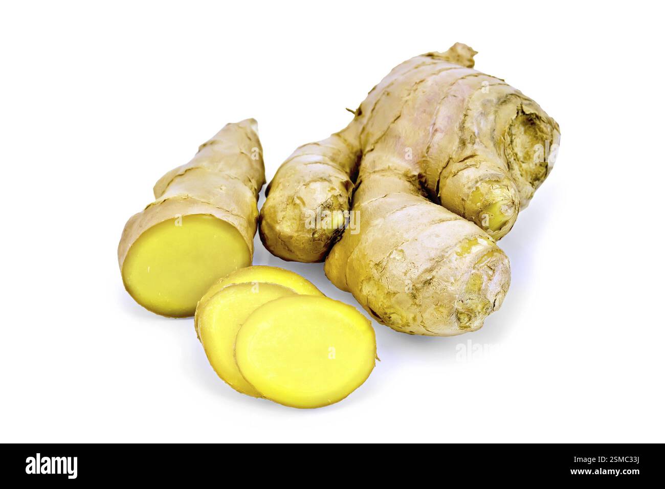 Ginger root cut into slices and whole isolated on a white background ...