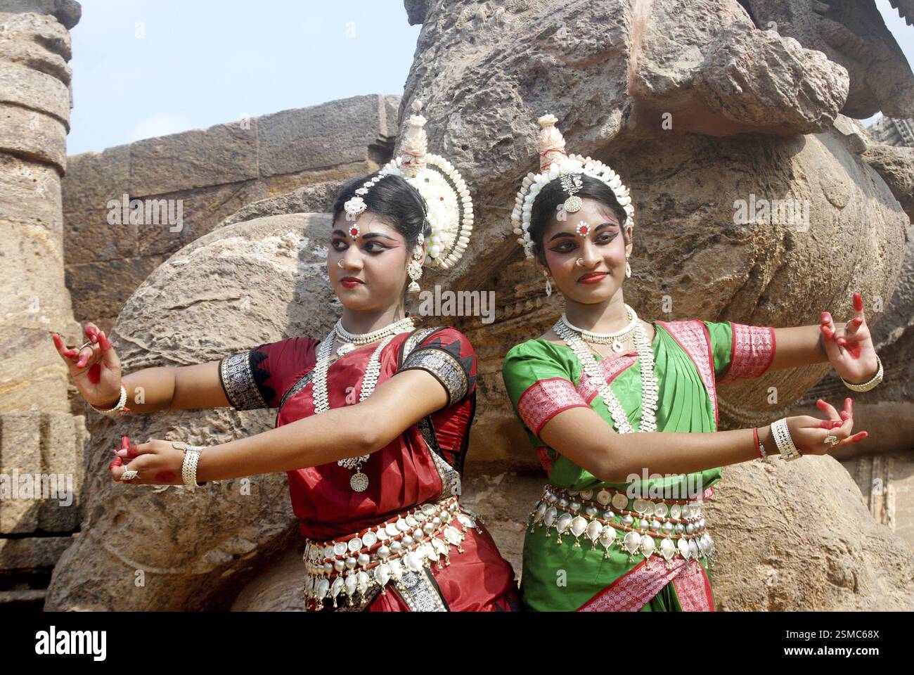 Dancers performing classical traditional odissi dance at statues of ...