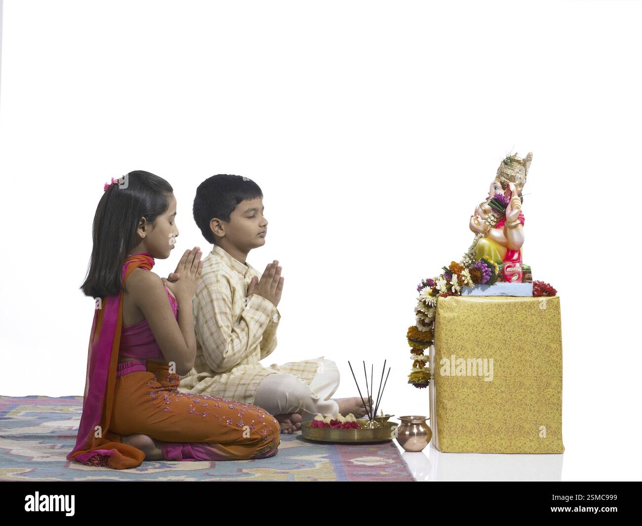 South Asian Indian two children brother and sister praying to Lord ...