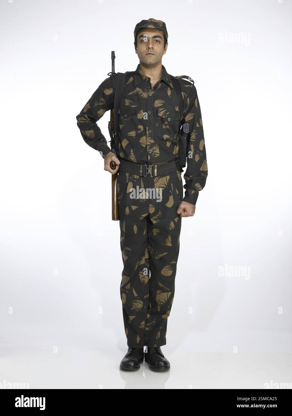 Indian army soldier with AK-47 gun standing in attention position MR ...