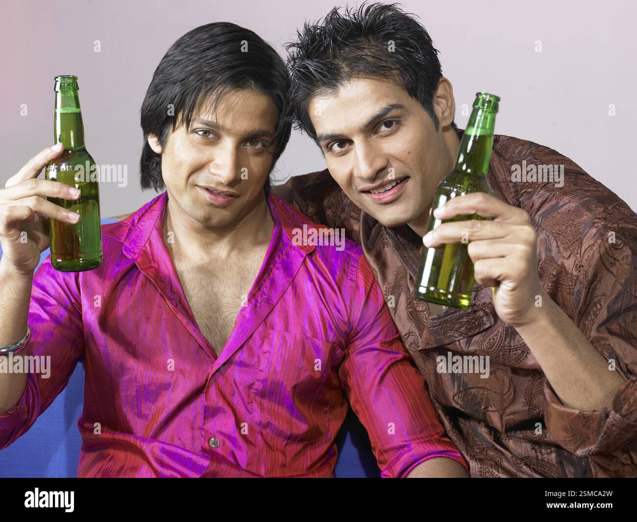 South Asian Indian men showing drink bottles celebrating party MR Stock ...