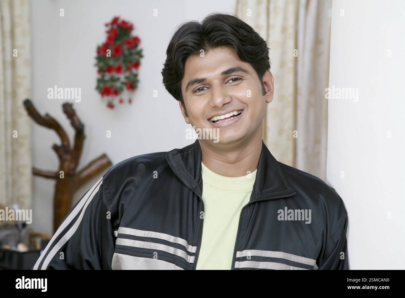 Young man resting to the pillar and smiling MR # 687C Stock Photo - Alamy