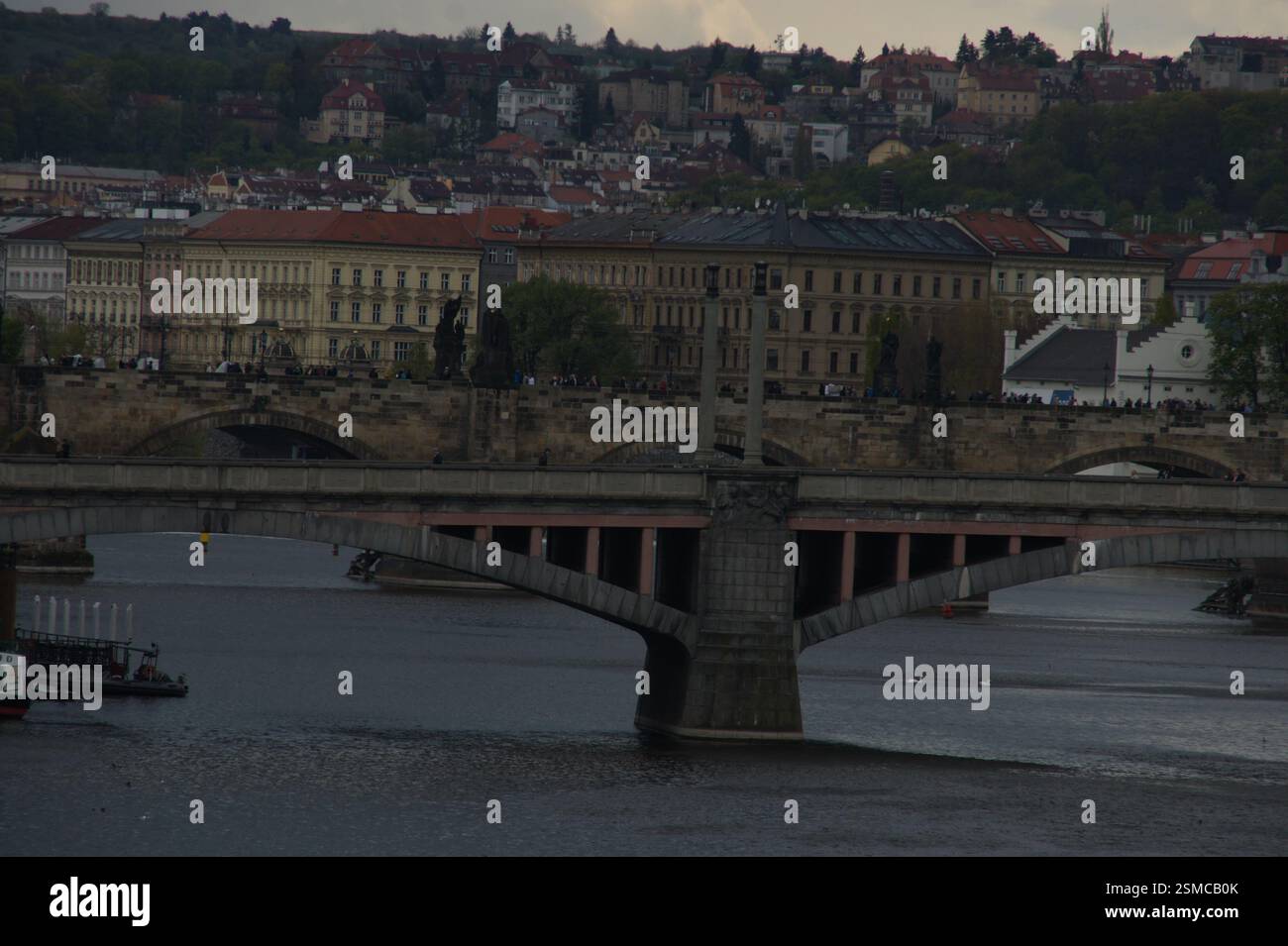 Bridge. Stone arches span a river, lined with historic buildings and ...