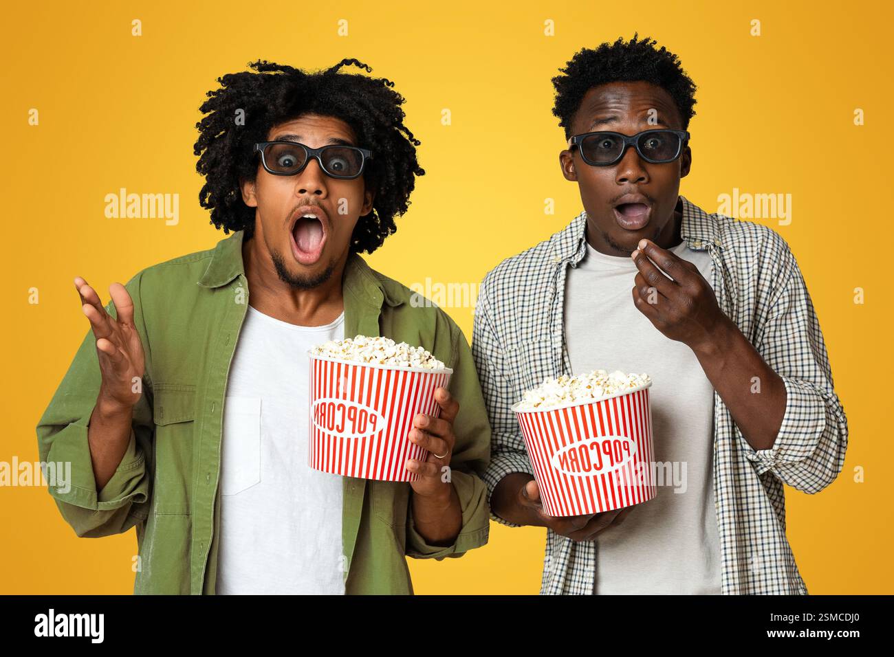 Exciting Movie. Shocked Black Guys In 3d Glasses Holding Popcorn Buckets Stock Photo - Alamy