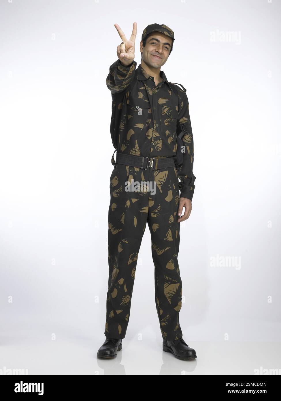 Indian army soldier standing in relaxed position showing victory sign ...