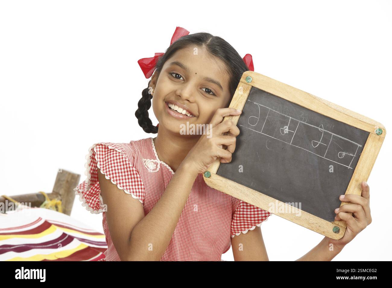 Ten years old girl showing four Marathi devnagri alphabets written on ...