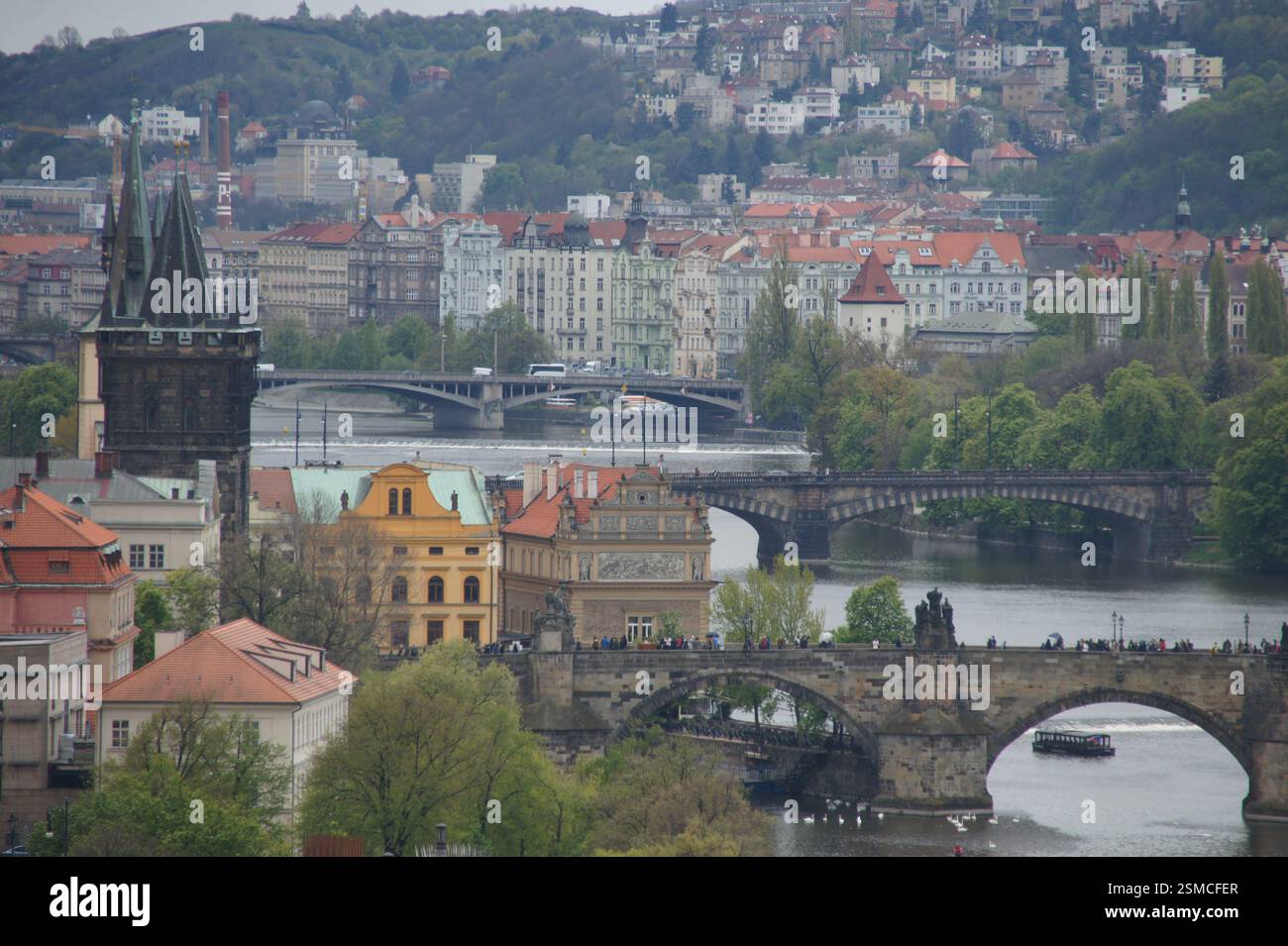 Prague skyline. Charles Bridge spans Vltava River, with Old Town Bridge Tower framing the view ...