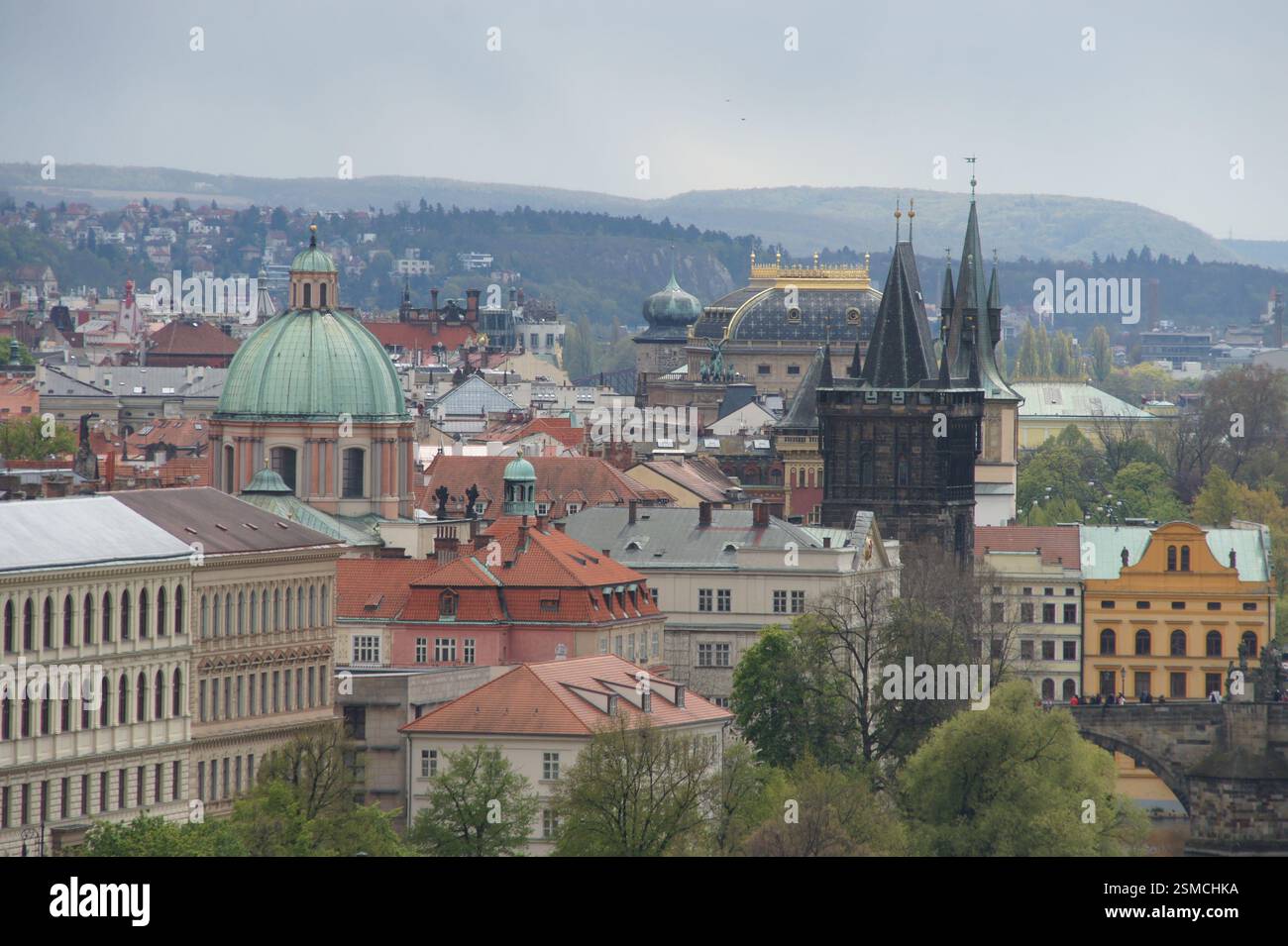 Prague skyline. Red rooftops and spires rise above the Vltava River ...