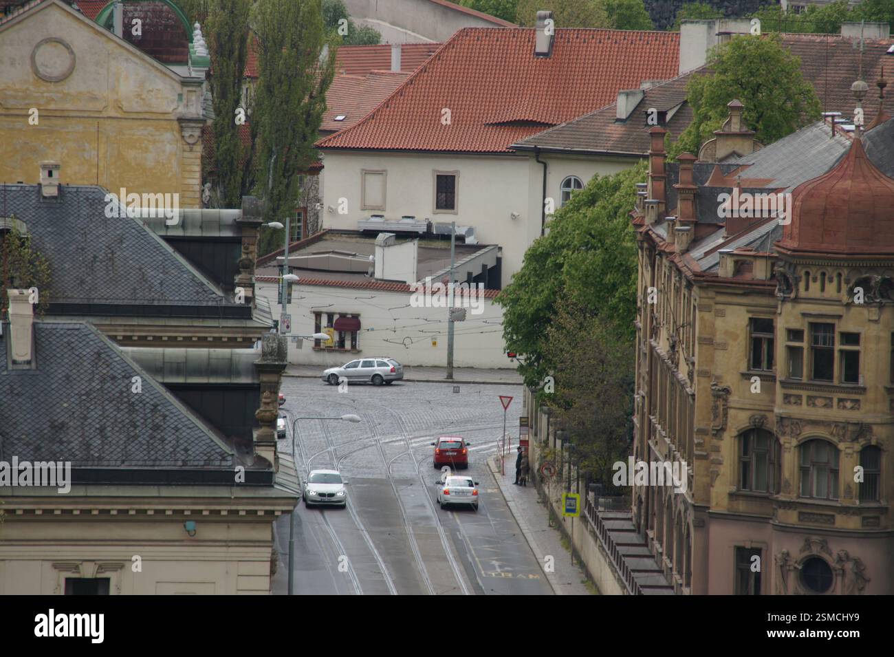 The photo depicts a charming street scene in the Czech Republic. Cars ...