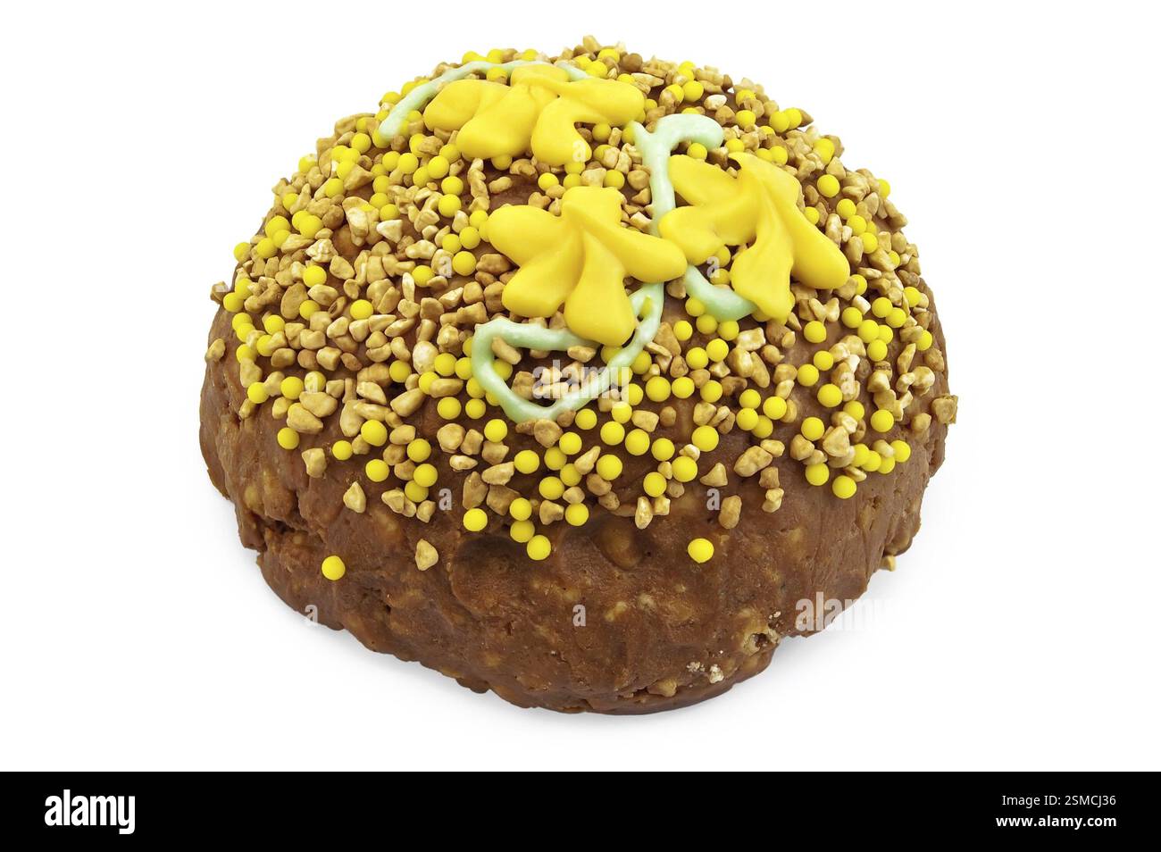 Brown sandy cake with yellow and green pattern of sweets and nuts ...
