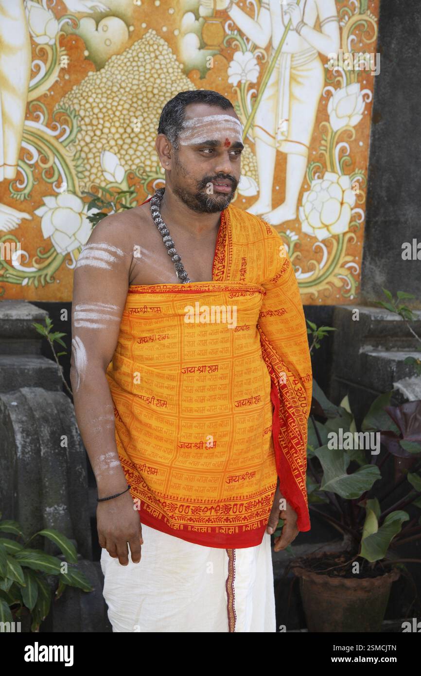 Religious preacher wearing rudraksha mala applying holy ash or bhasma ...