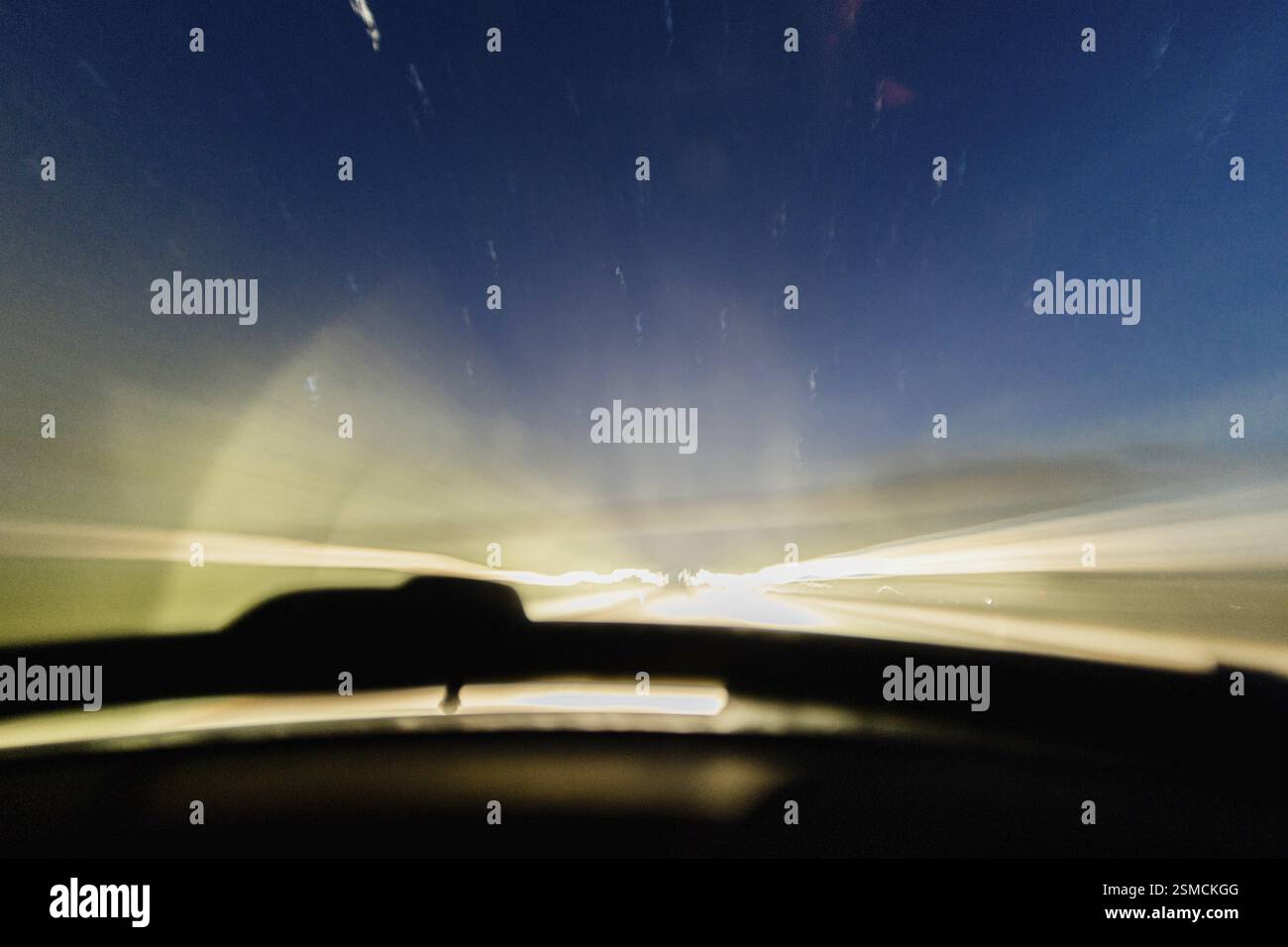 A dynamic scene capturing motion blur during a night drive under stars ...