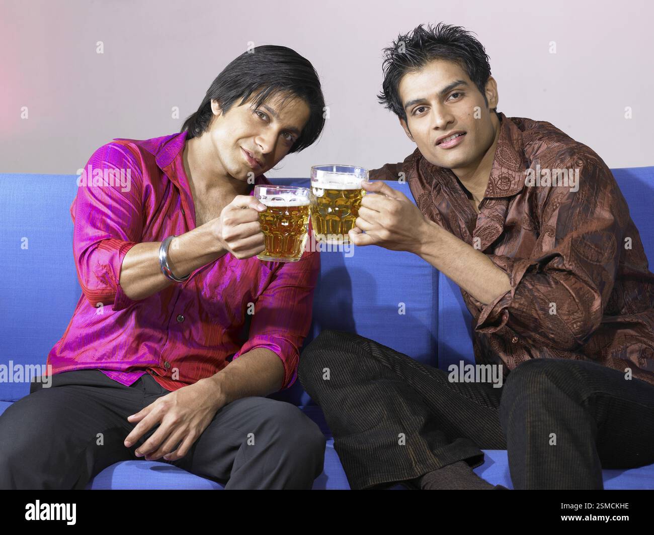 South Asian Indian men toasting drink glasses celebrating party MR ...