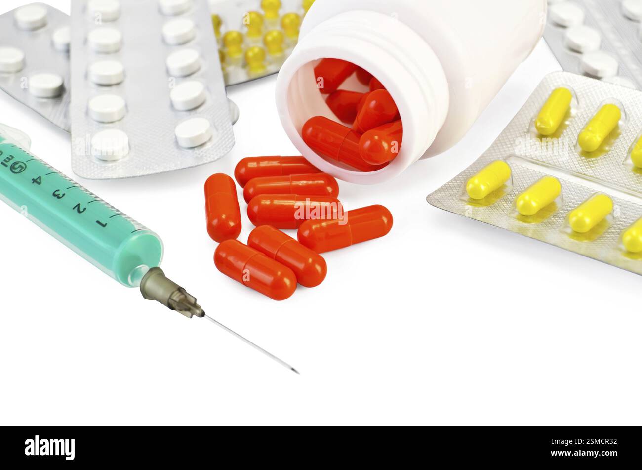 Red capsules in a jar, yellow capsules and tablets in packs, syringe ...