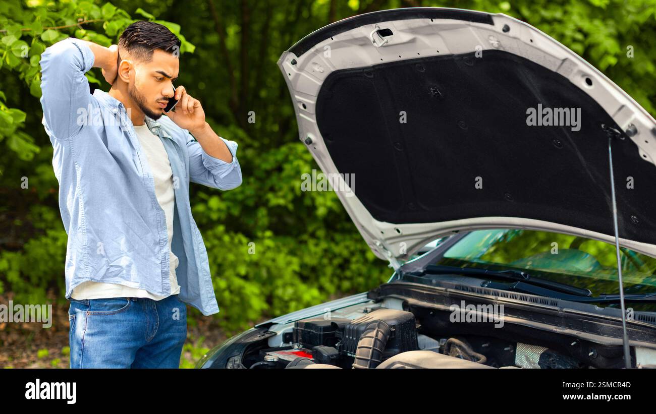 Sad arab man looking at engine and calling auto service Stock Photo - Alamy