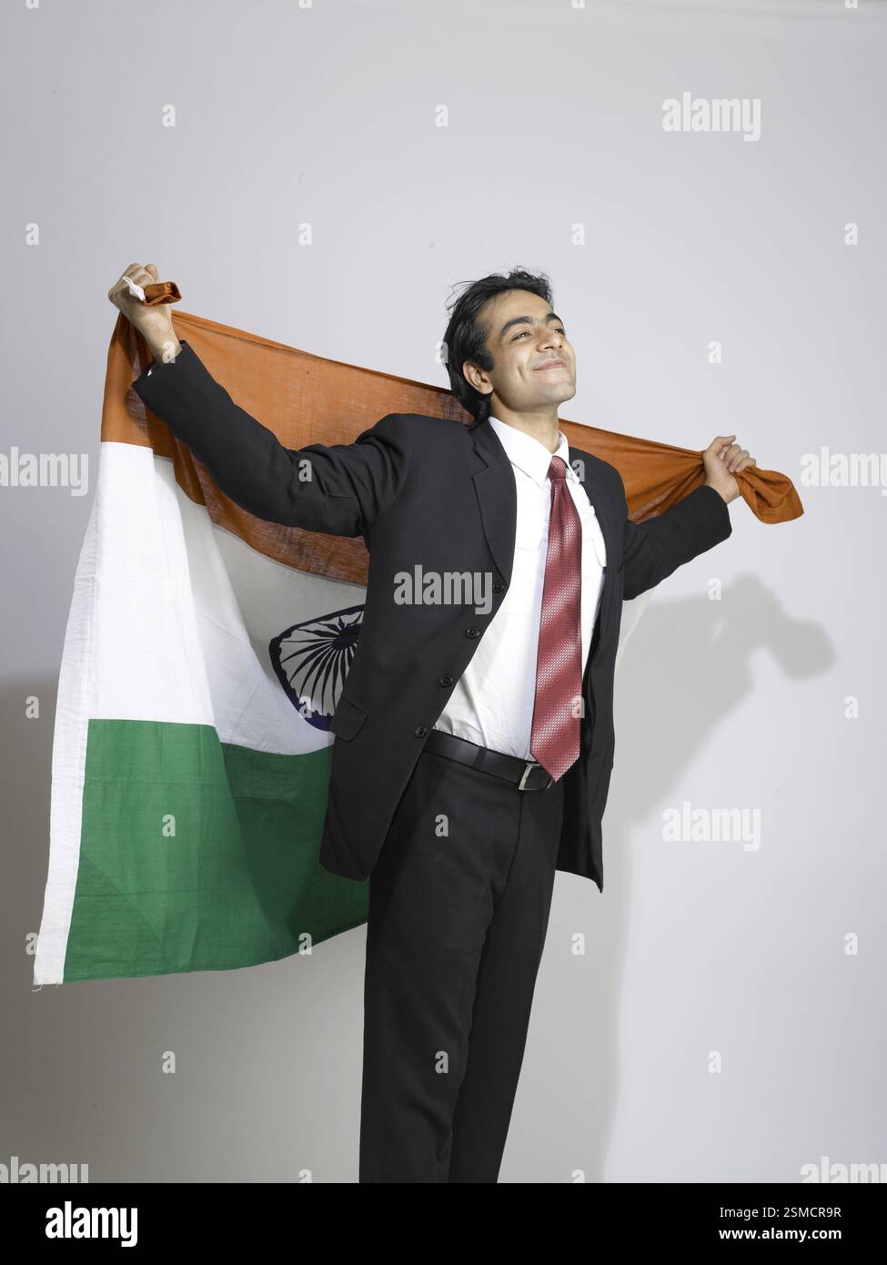 South Asian Indian executive holding flag of India on his backside MR ...