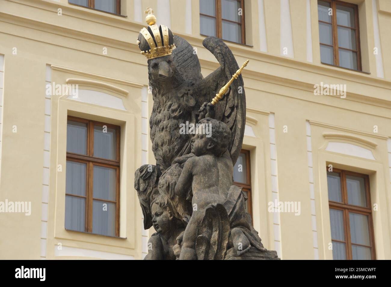 Prague Castle statue. Baroque sculpture of a crowned eagle with putti ...