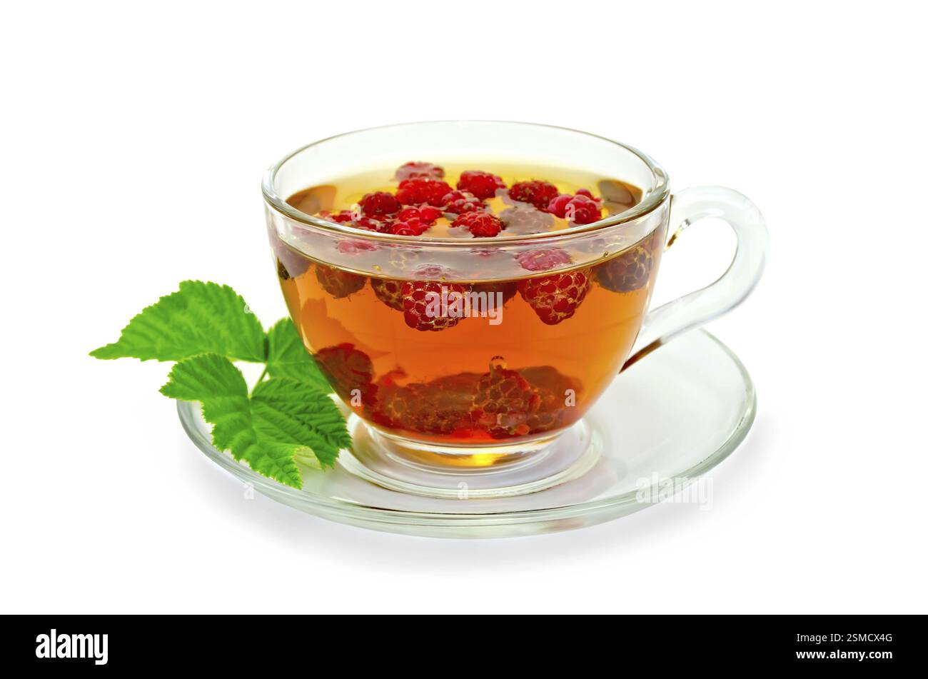 Tea with raspberries in a glass cup, green leaf raspberry isolated on a ...