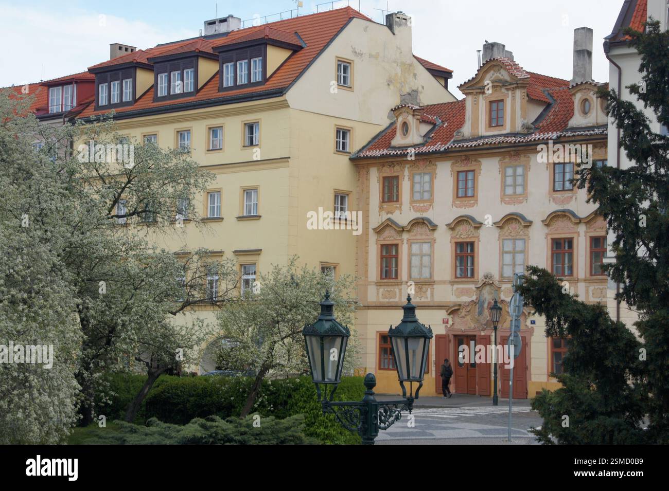 Dům U Černého vola. Baroque building with ornate facade and red tiled roof. Yellow building with ...