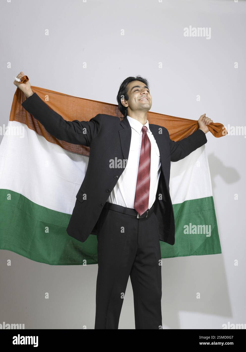 South Asian Indian executive holding flag of India on his backside MR ...