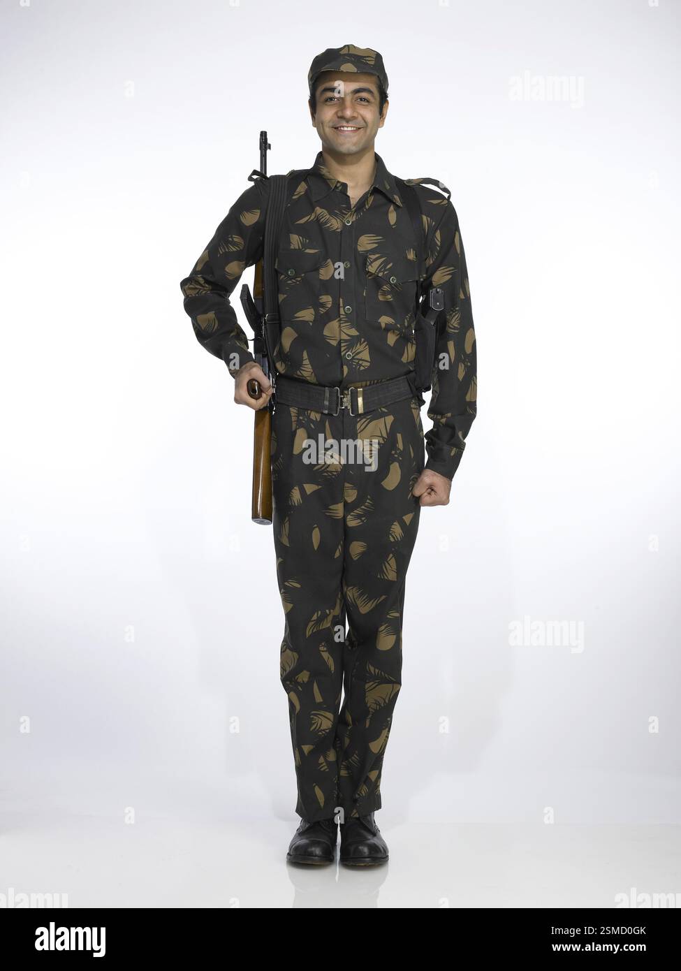 Indian army soldier with AK-47 gun standing in attention position and ...