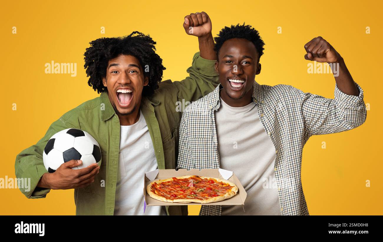 Two Excited Black Football Fans Holding Soccer Ball And Pizza Stock ...