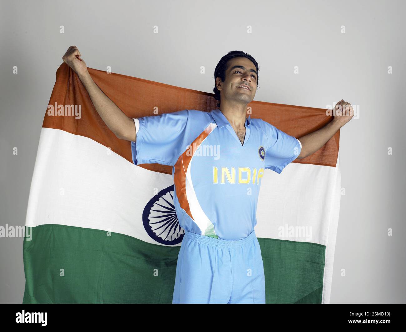 Indian cricket player holding flag of India in his backside MR#702A ...