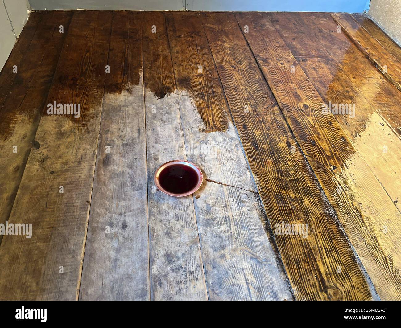 Wooden floor partially stained, showing contrast between new and old ...