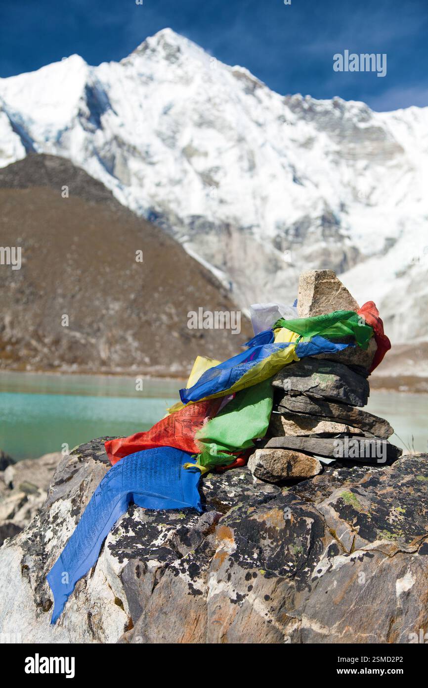Mount Cho Oyu and stone pyramid with prayer flags, way to Cho Oyu base ...