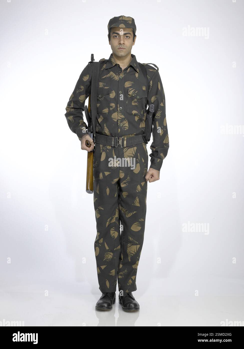 Indian army soldier with AK-47 gun standing in attention position MR ...