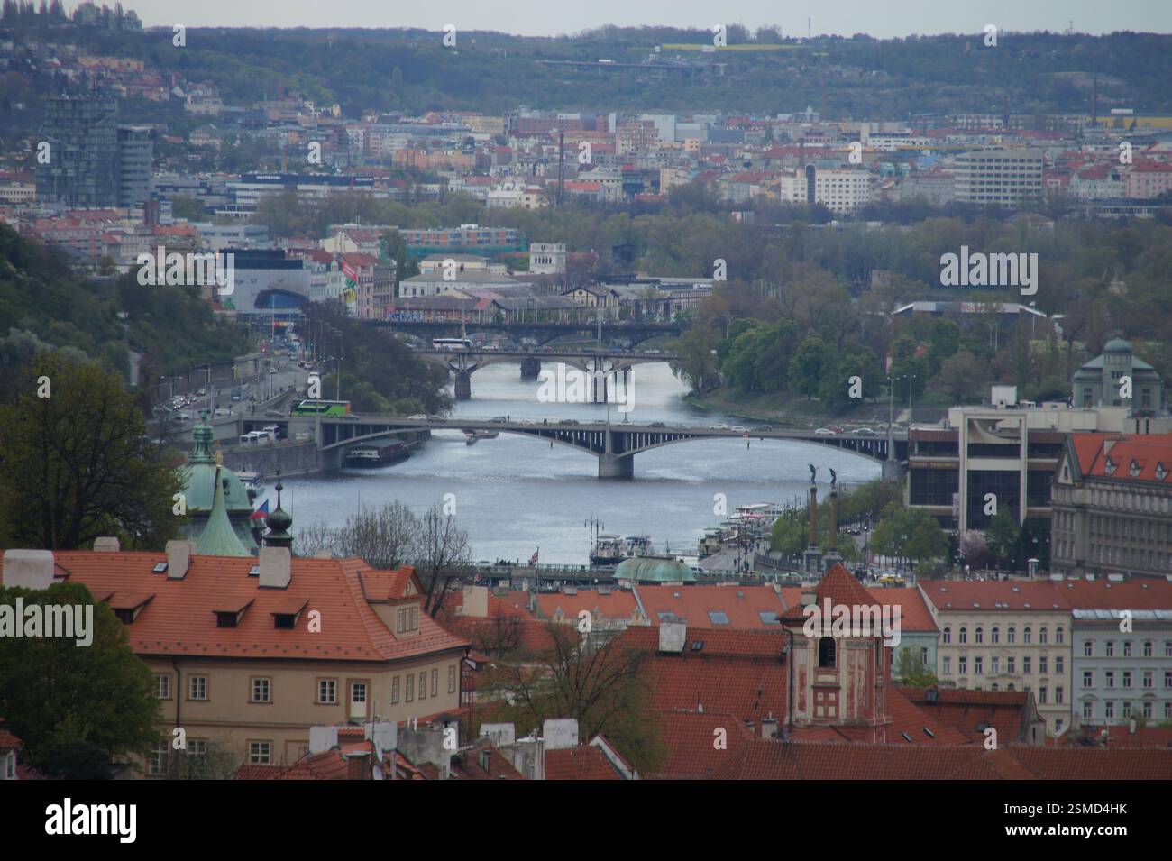 Prague panorama. Red rooftops line the Vltava River. Multiple bridges ...