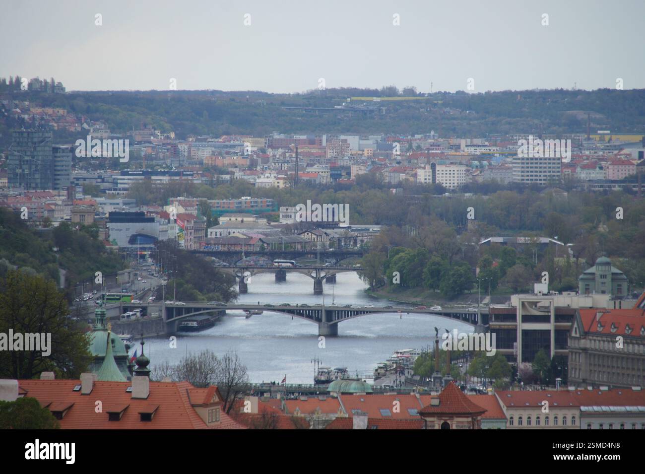 Prague panorama. Red rooftops line the Vltava riverbank, with bridges ...