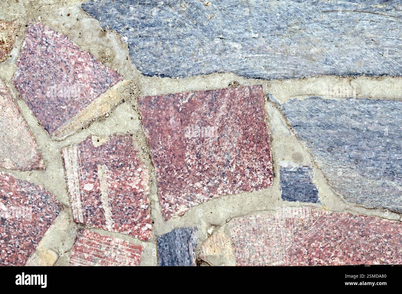 The wall, built of pieces of red and black granite of various sizes ...