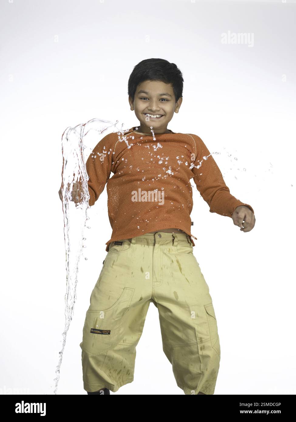 Water splashing on South Asian Indian boy in nursery school MR Stock ...