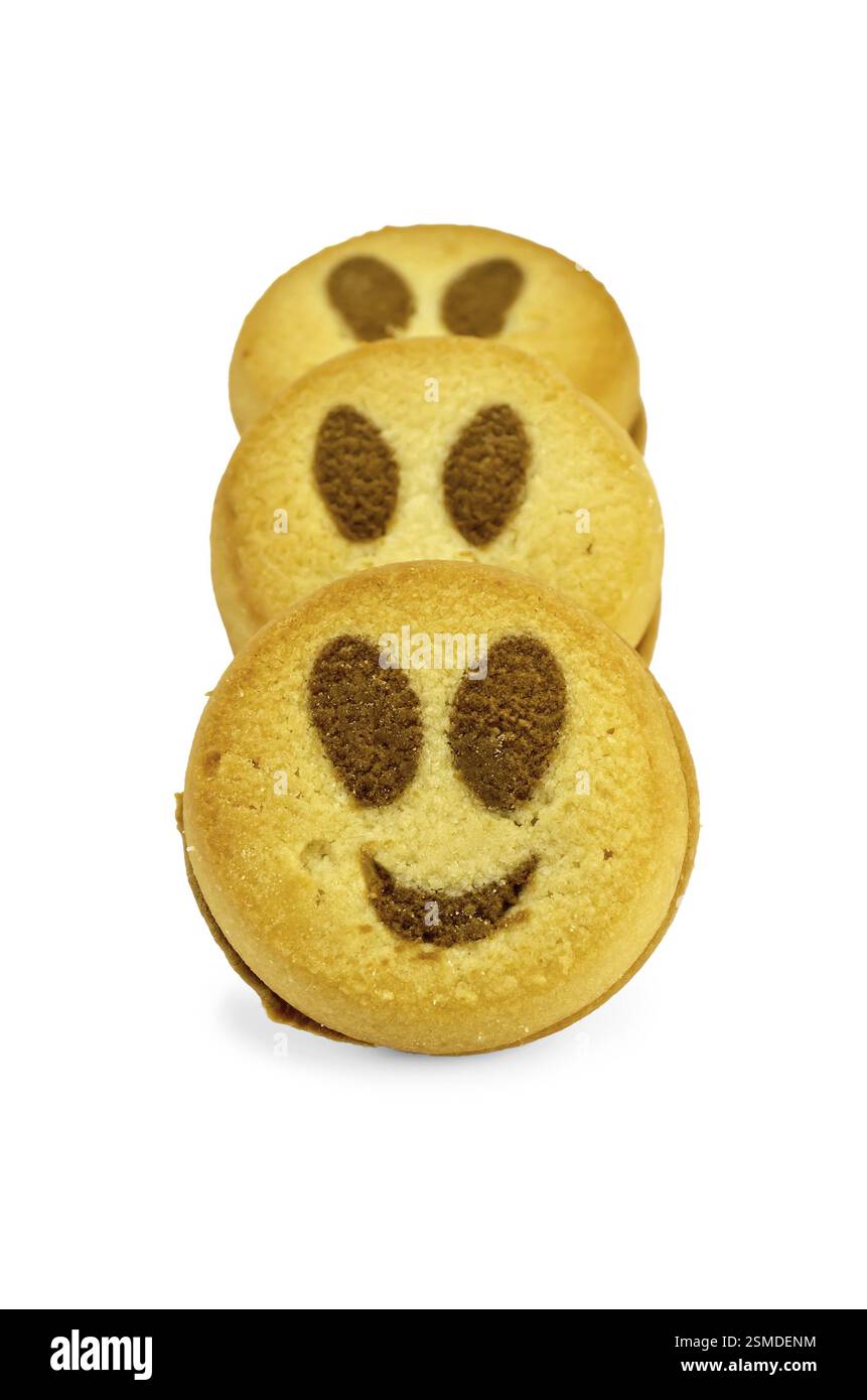 Three biscuits with images of eyes and mouth as a smiley face isolated ...