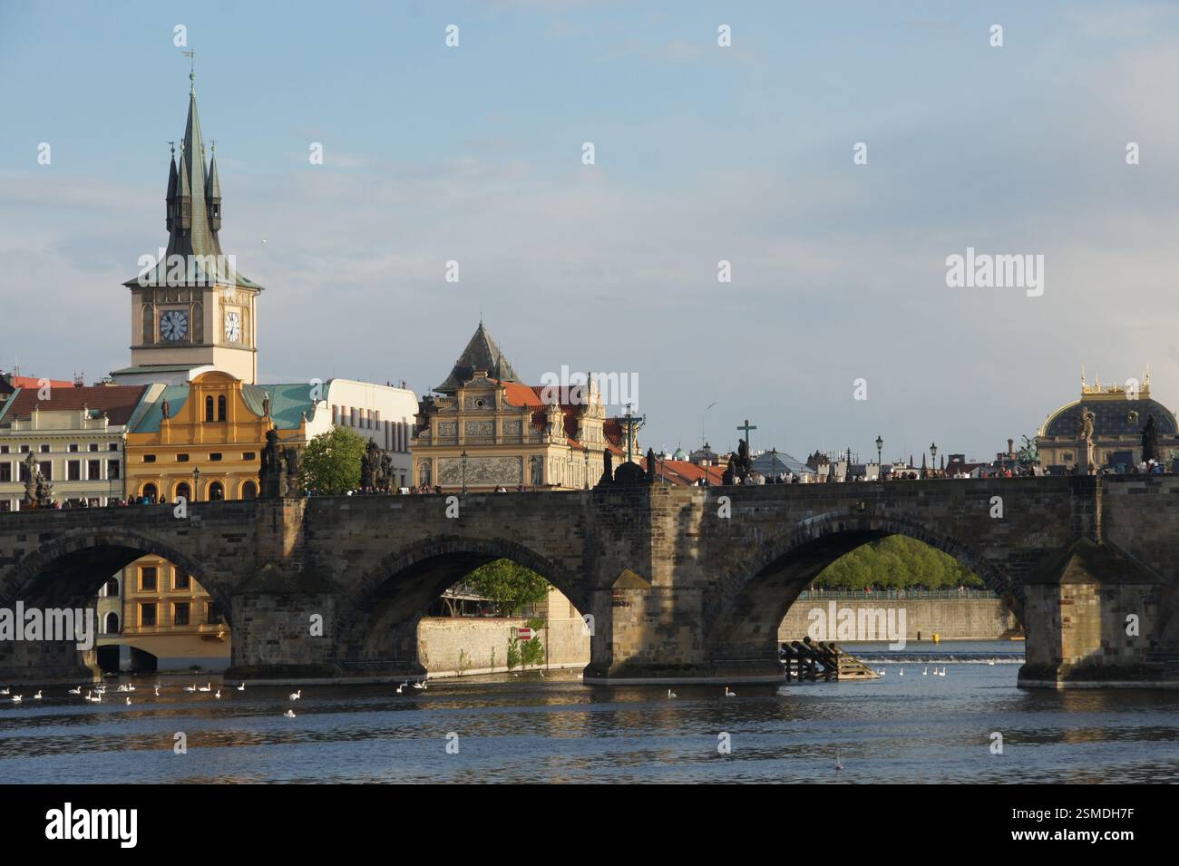 Charles Bridge is a stone bridge with multiple arches spanning the ...