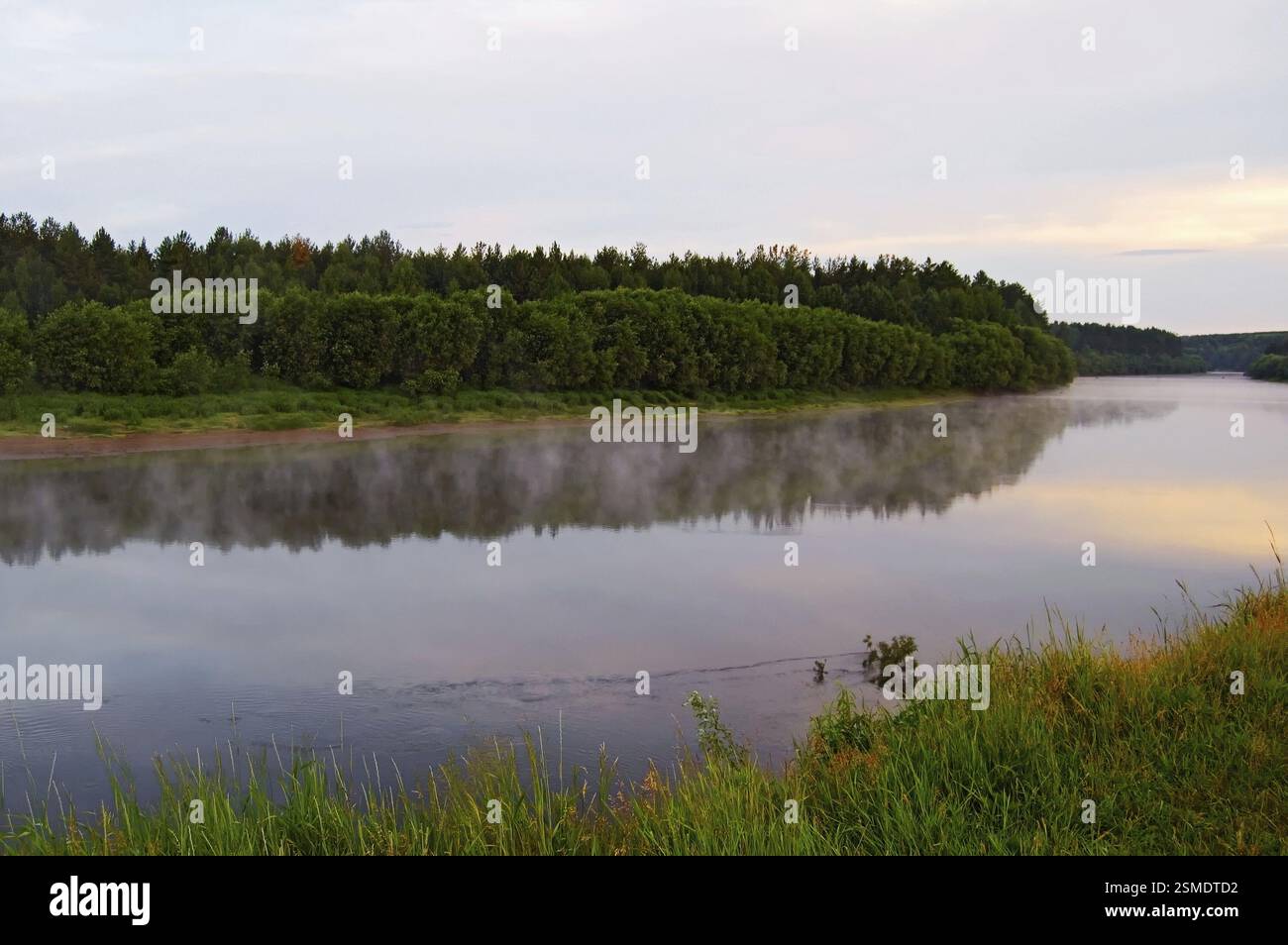 A beautiful sunrise on the river Sosva in the Northern Urals, clouds, painted in red, orange ...