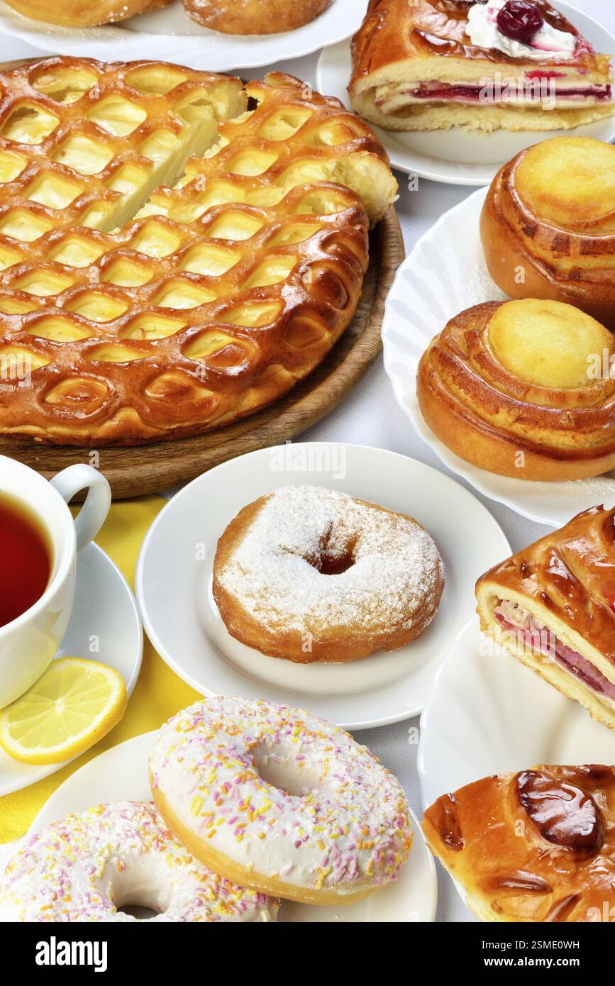 Still life of setout table with baking pies, donuts and tee cup . Image ...