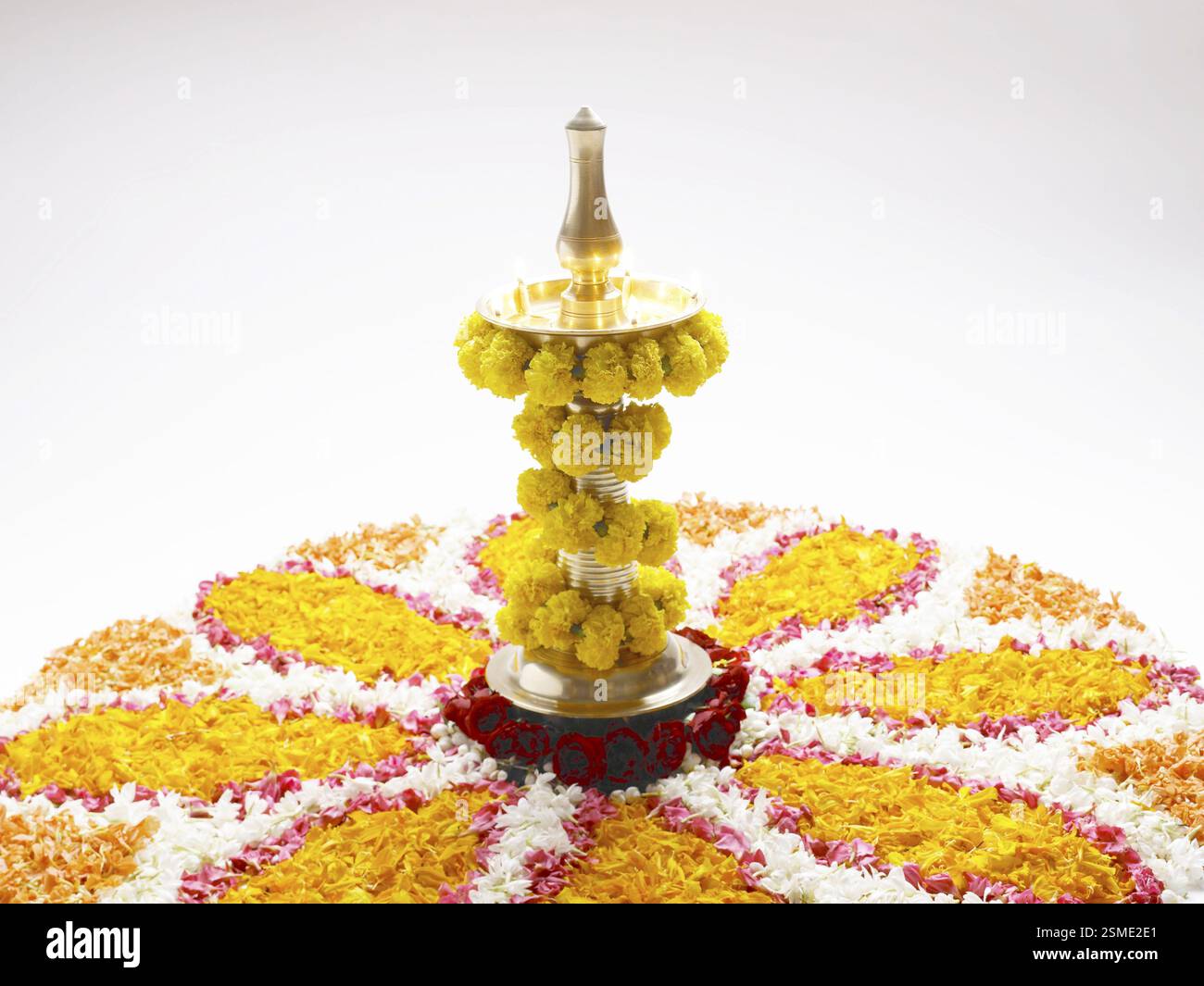 Onam Kerala festival, diya with flower design Stock Photo - Alamy