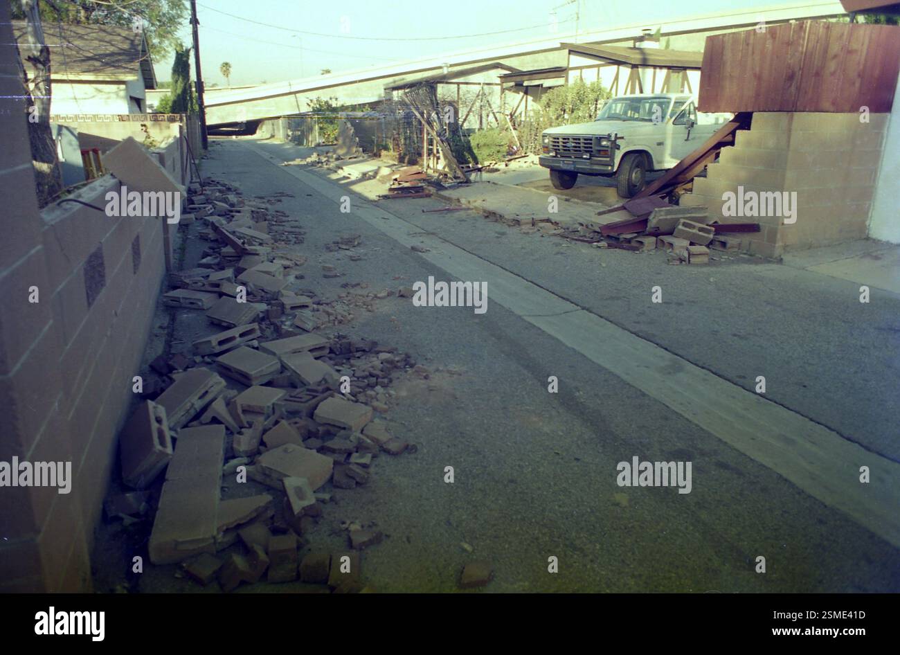 Los Angeles, CA, USA, January 1994. A concrete blocks fence fallen ...